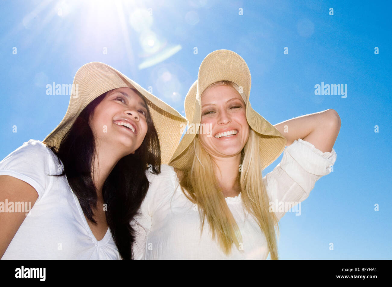 Women in hats smiling Stock Photo - Alamy
