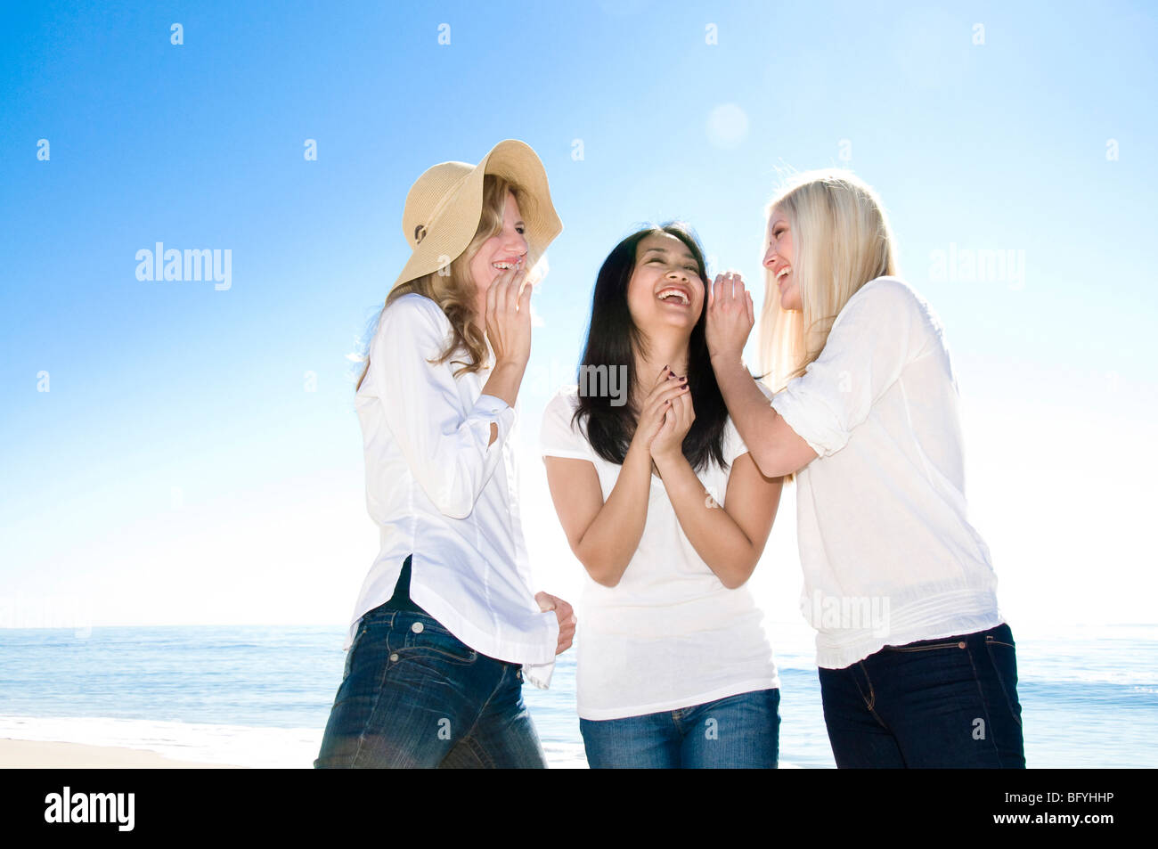 Women laughing on beach Stock Photo - Alamy