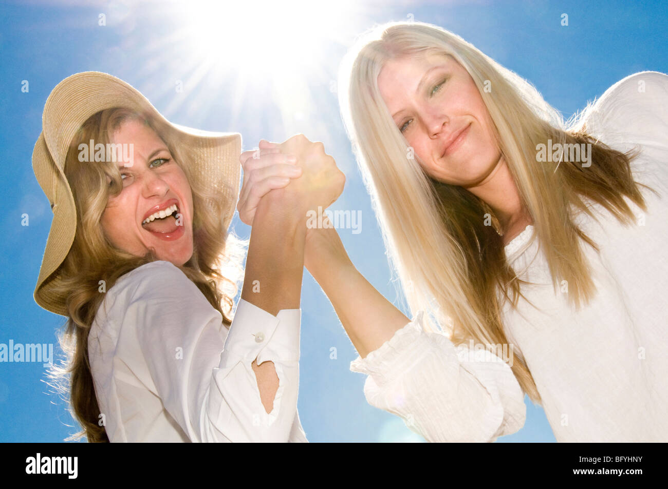 Women holding hands Stock Photo - Alamy