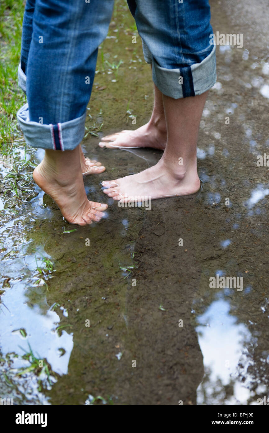 Feet In Puddle Stock Photo - Alamy