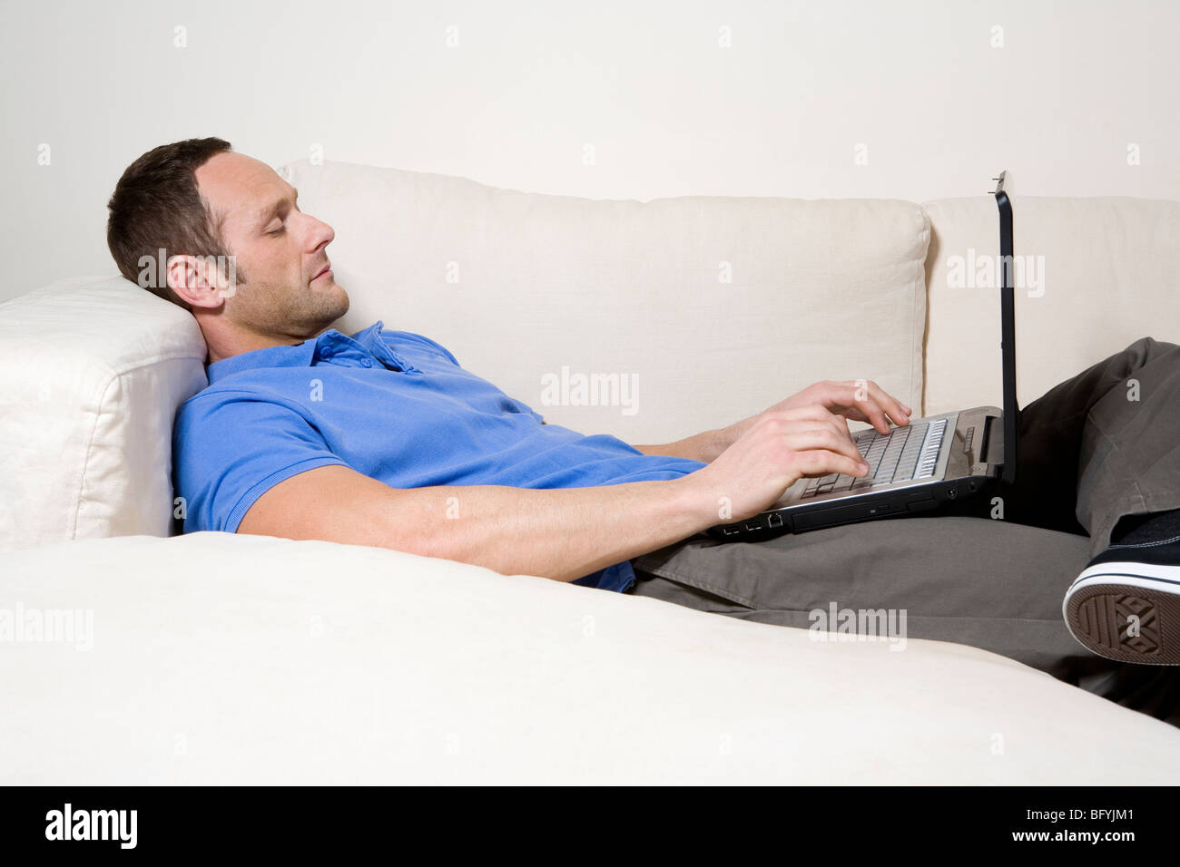Man surfing the net at home Stock Photo - Alamy