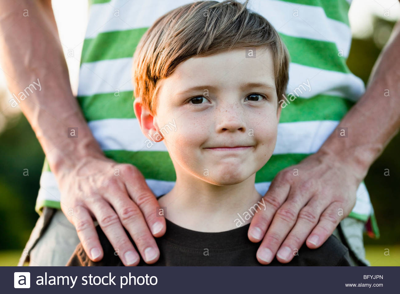 Father With Hands On Sons Shoulders Stock Photo: 27037661 - Alamy