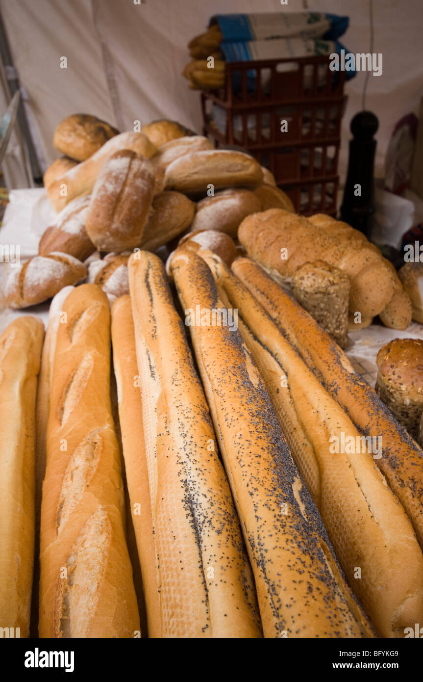 Long rolls of bread laid out at continental food market on sale ...