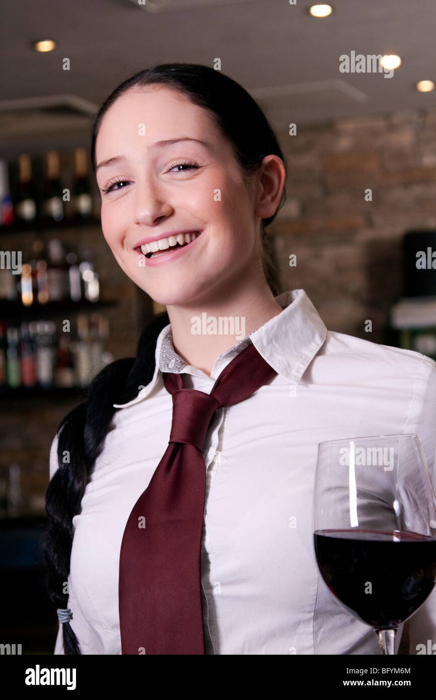 portrait of young waitress serving wine Stock Photo - Alamy