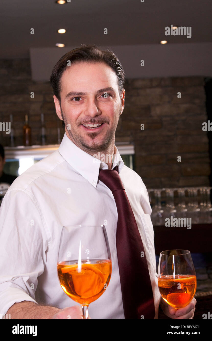 portrait of waiter serving drinks Stock Photo - Alamy