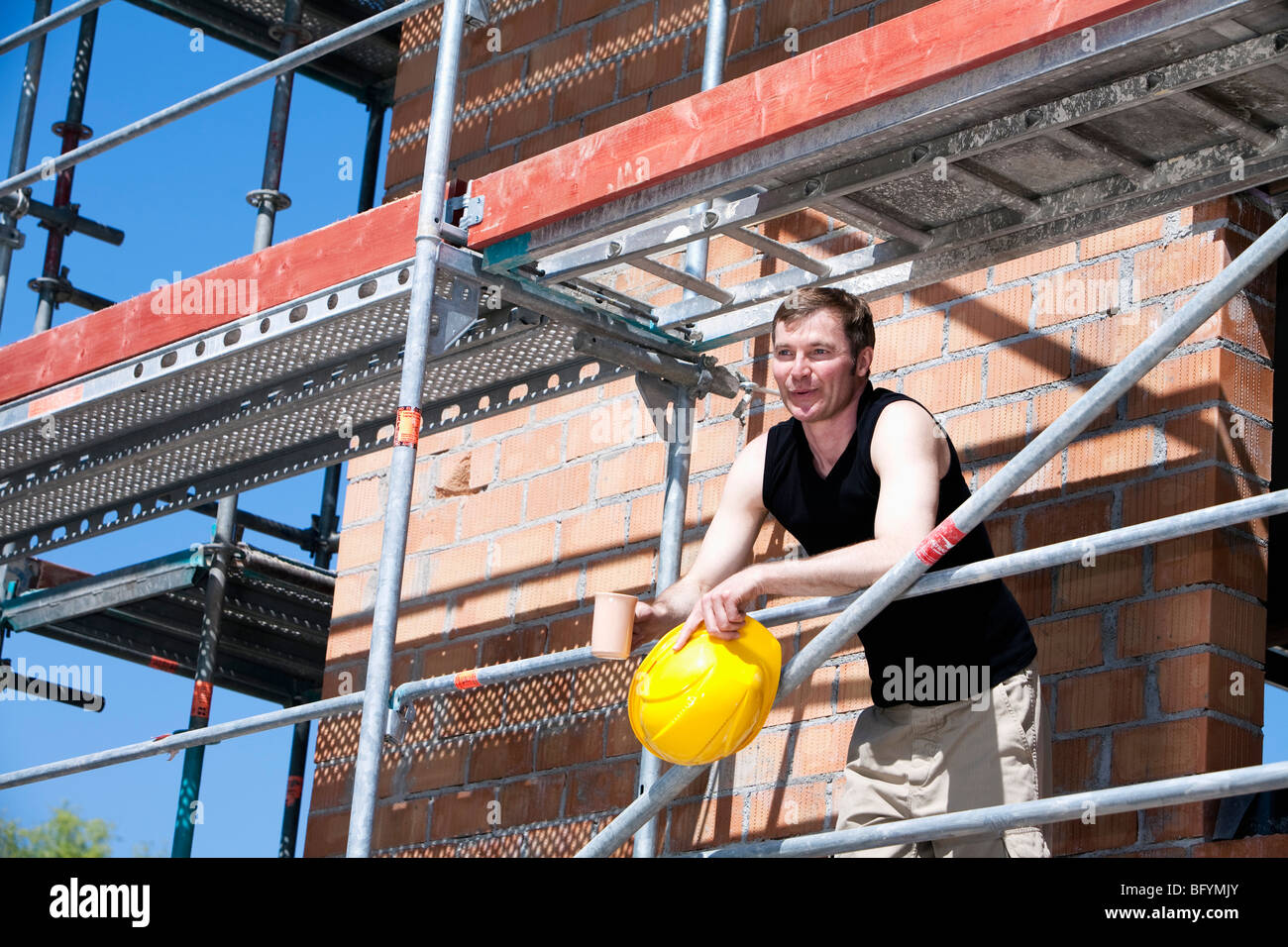portrait of construction worker taking a break on scaffolding Stock ... portrait of construction worker taking a break on scaffolding Stock ...
