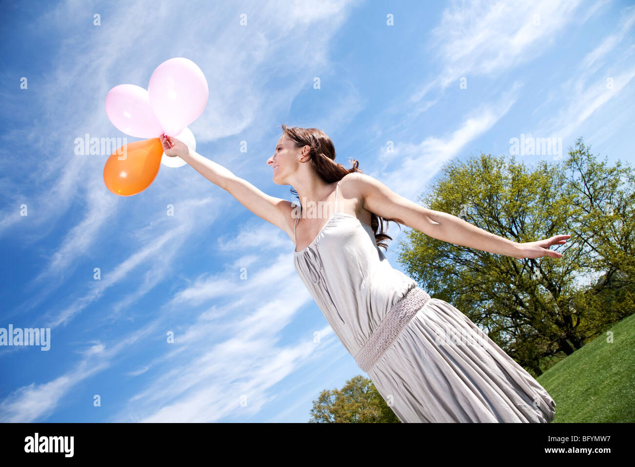 Woman with balloons floating people hi-res stock photography and images ...