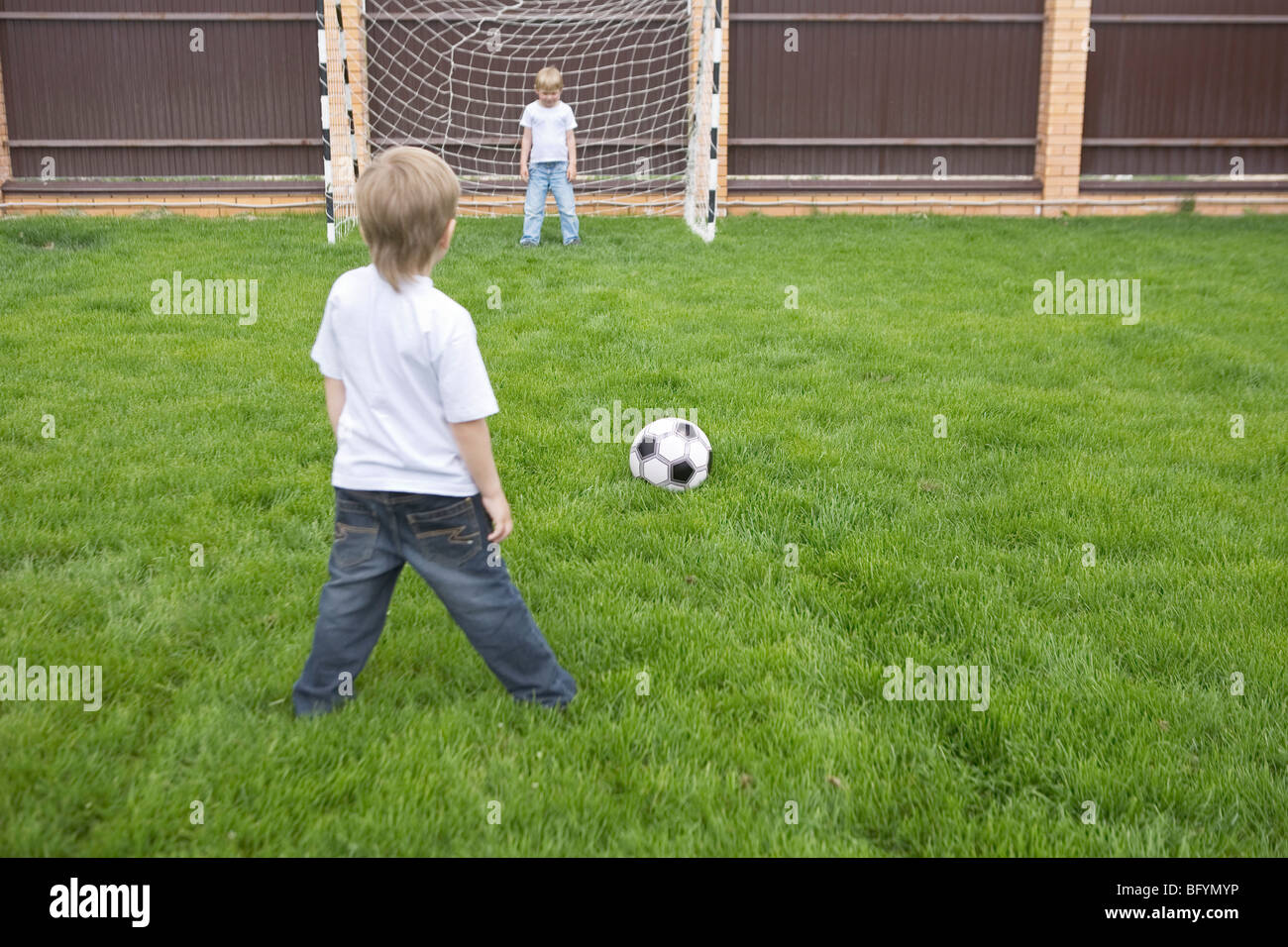 rear view of young boy waiting to kick football Stock Photo - Alamy