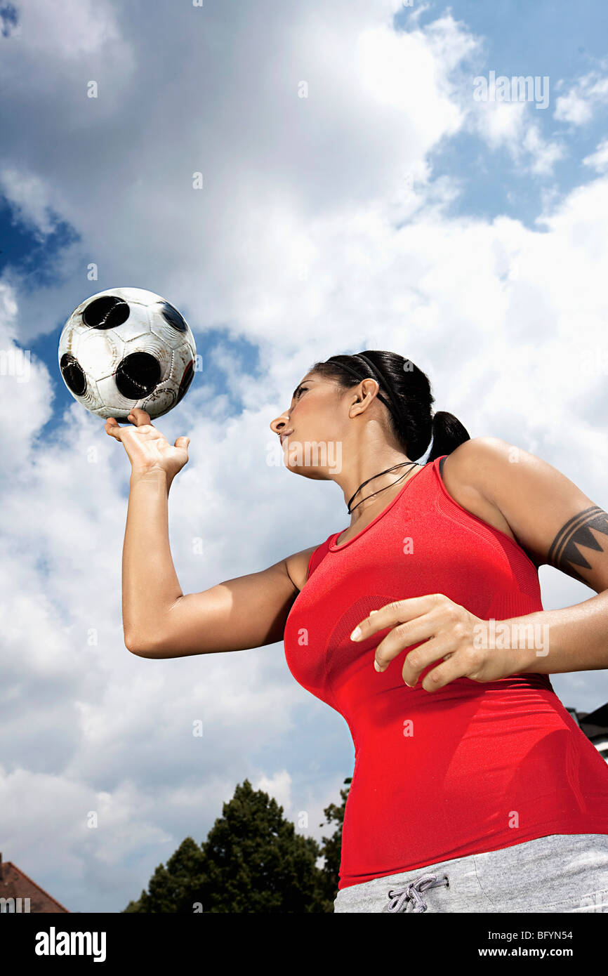Female football player standing ball hi-res stock photography and ...