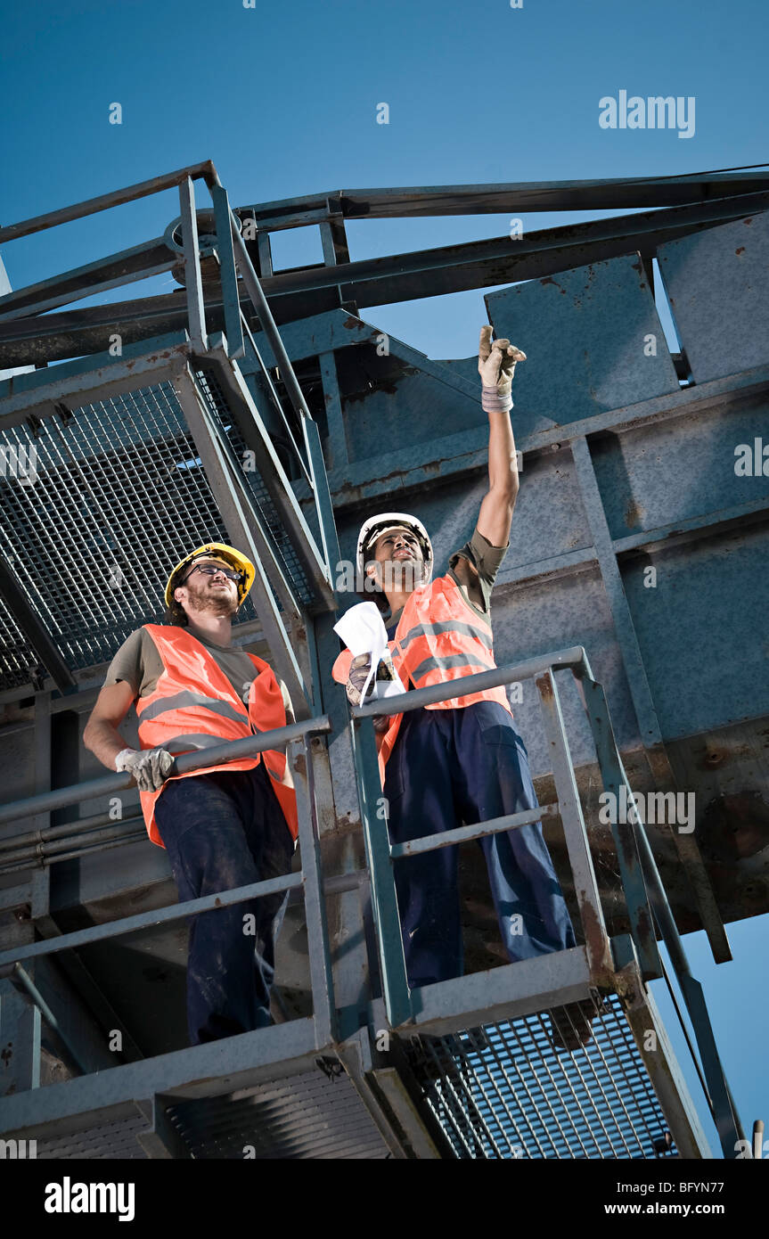 two workers having conversation on excavator Stock Photo - Alamy