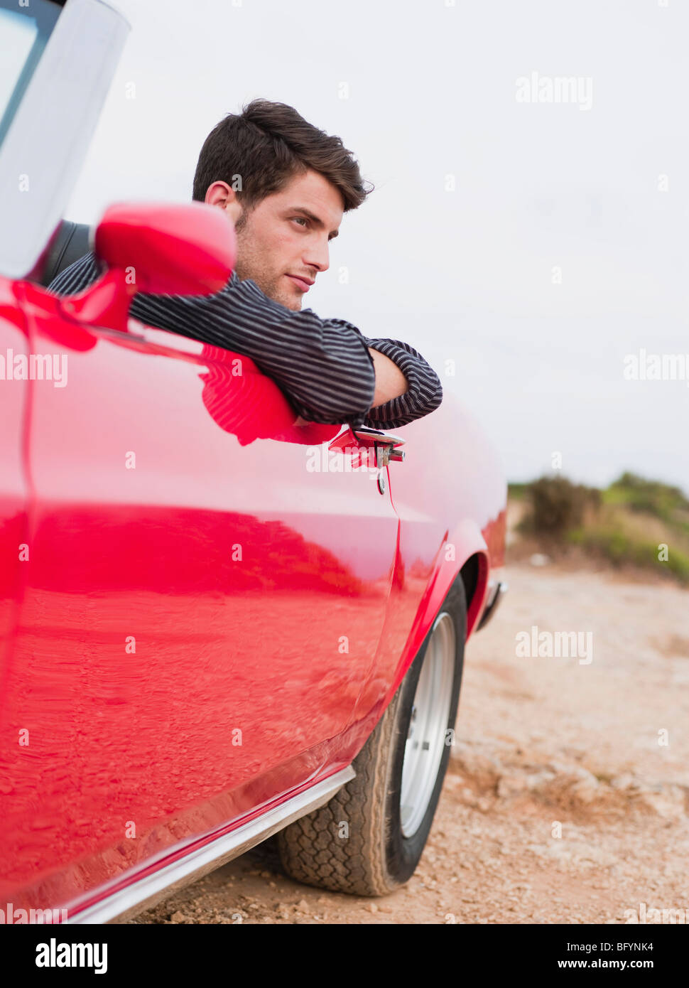 man leaning out of an open-topped car Stock Photo - Alamy