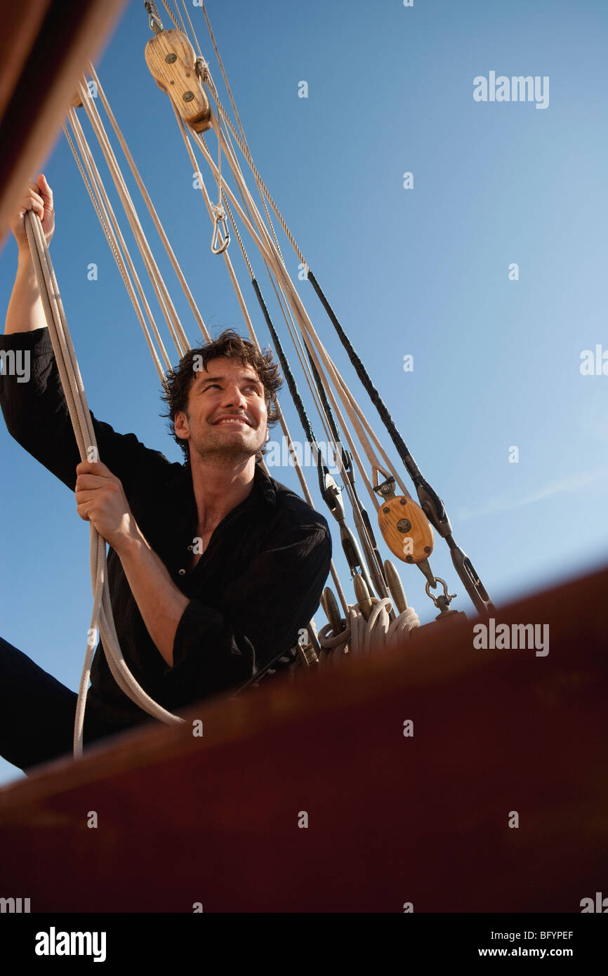 Man adjusting rigging on sailboat hi-res stock photography and images ...