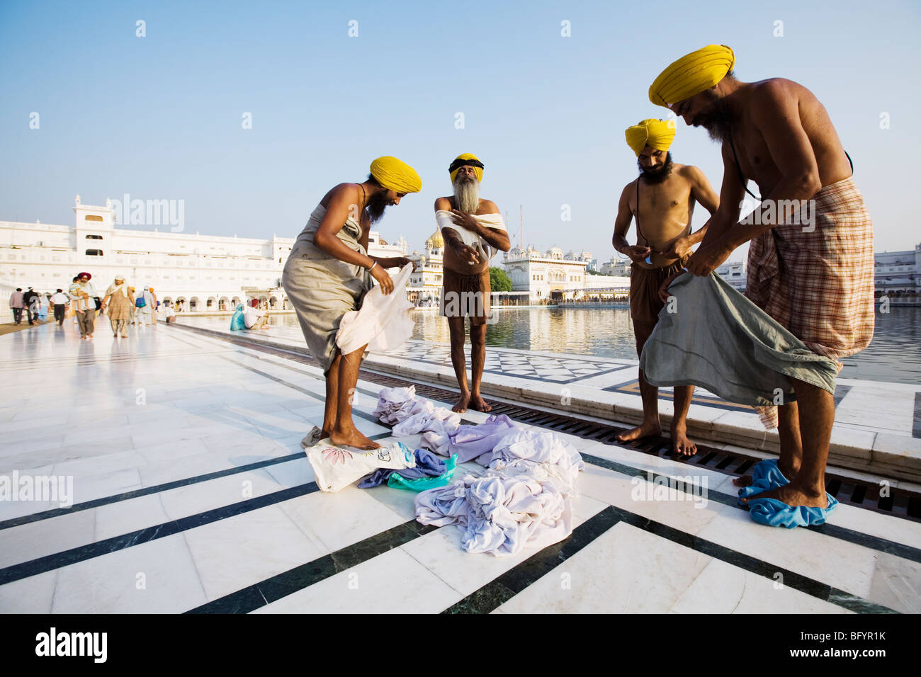 Sikh men preparing for a religious bath in Golden Temple, Amritsar ...