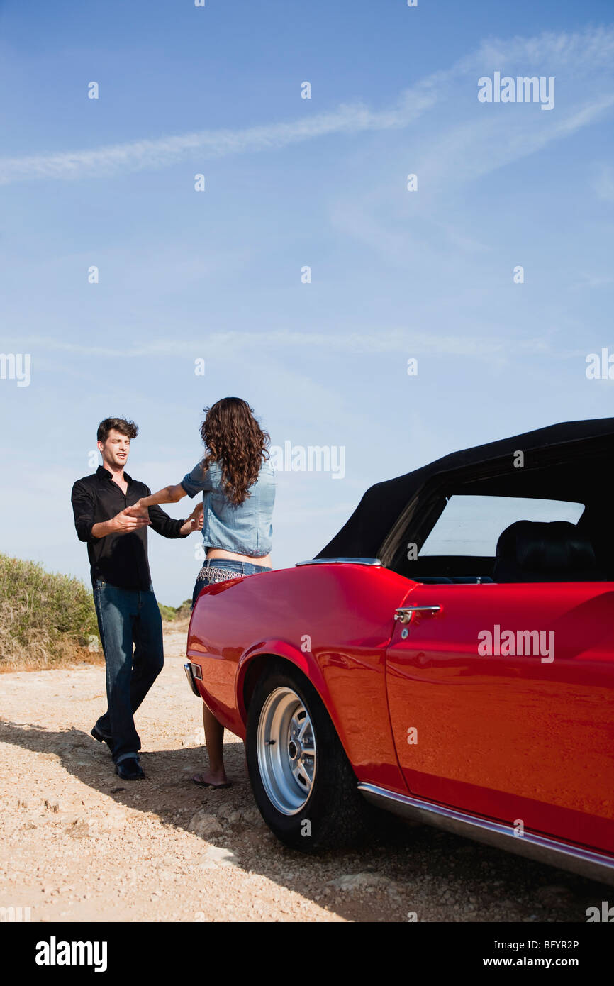 couple holding hands next to car Stock Photo - Alamy
