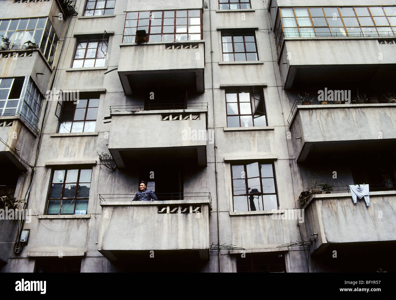 Man stands on balcony of his apartment in Beijing, China Stock Photo ...