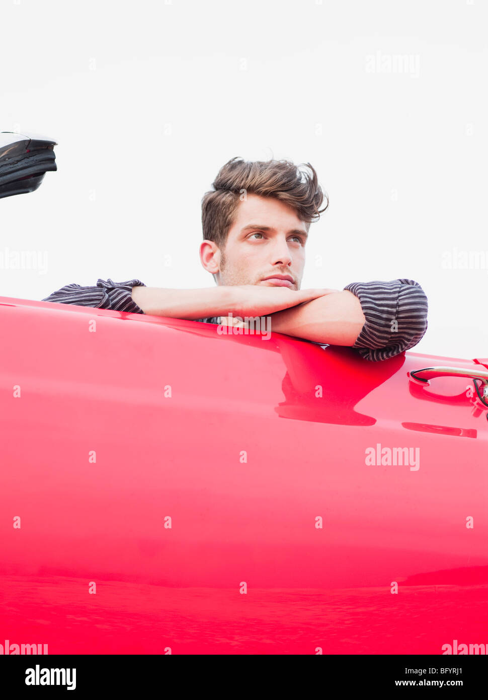 man looking over the side of car door Stock Photo - Alamy
