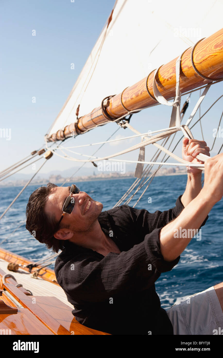 Man adjusting rigging on sailboat hi-res stock photography and images ...