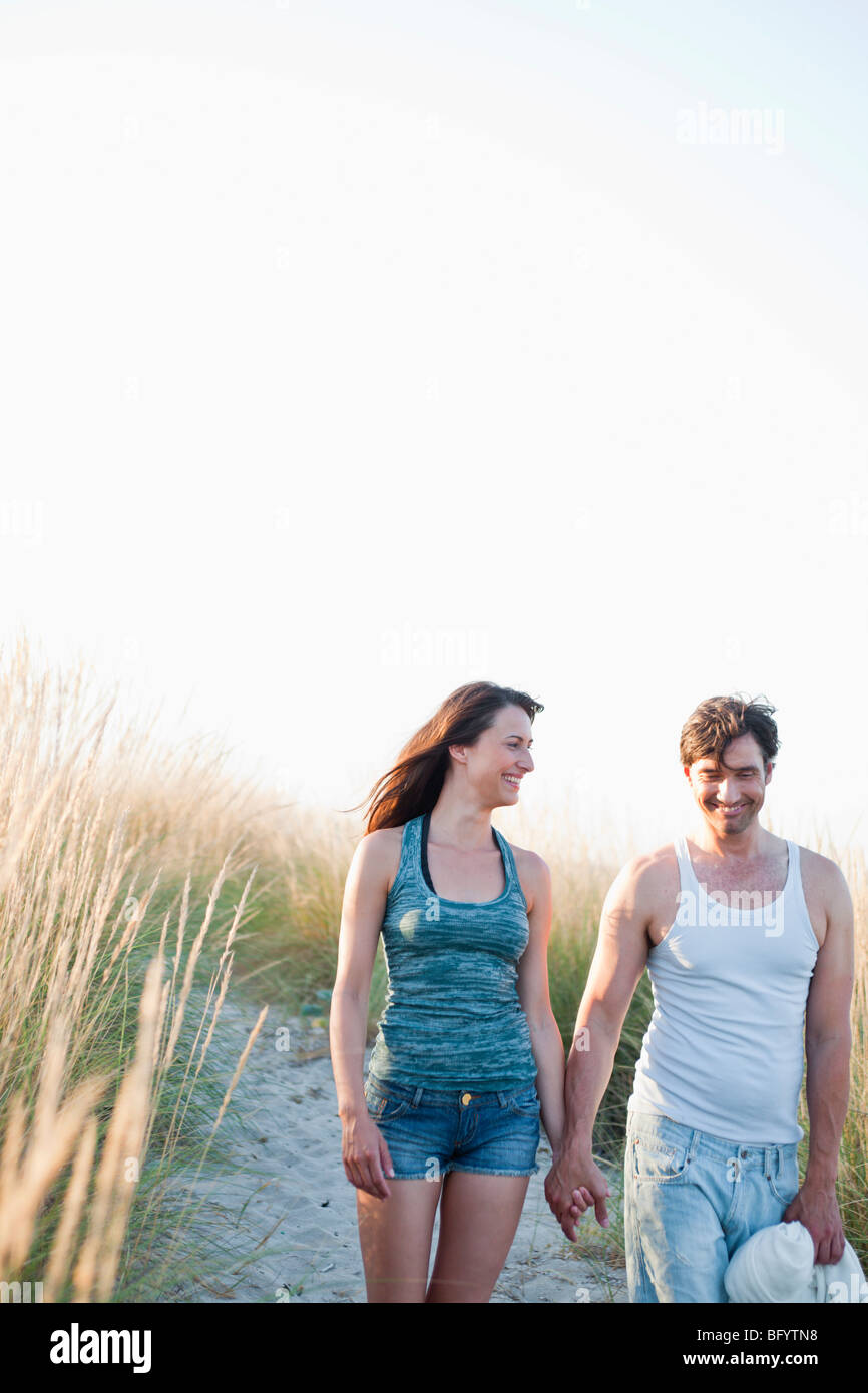 couple strolling along beach Stock Photo - Alamy