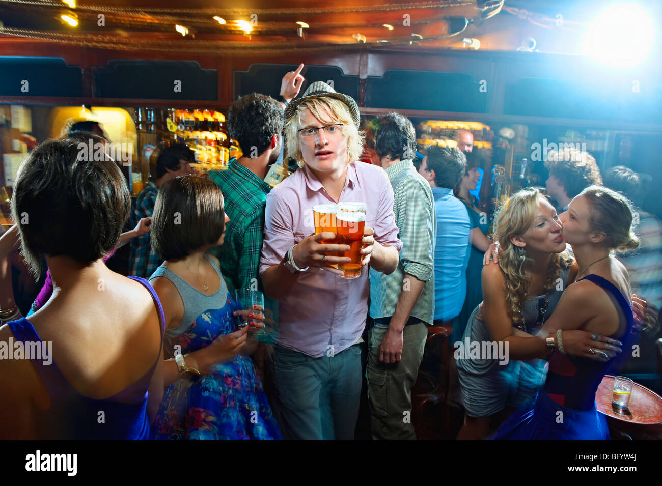 Group of young people in pub Stock Photo - Alamy
