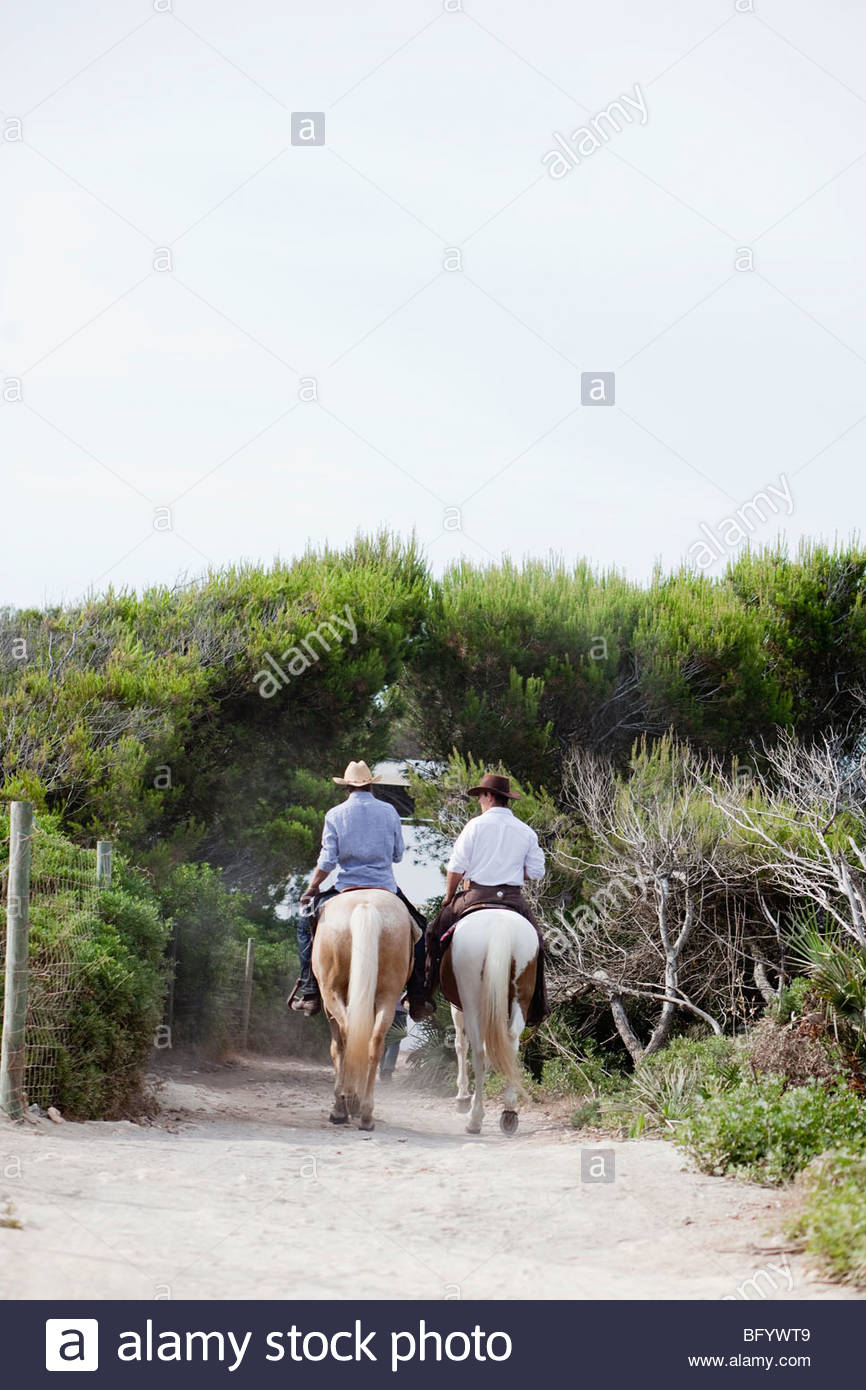 Two Men Horseback Riding Stock Photos & Two Men Horseback Riding Stock ...