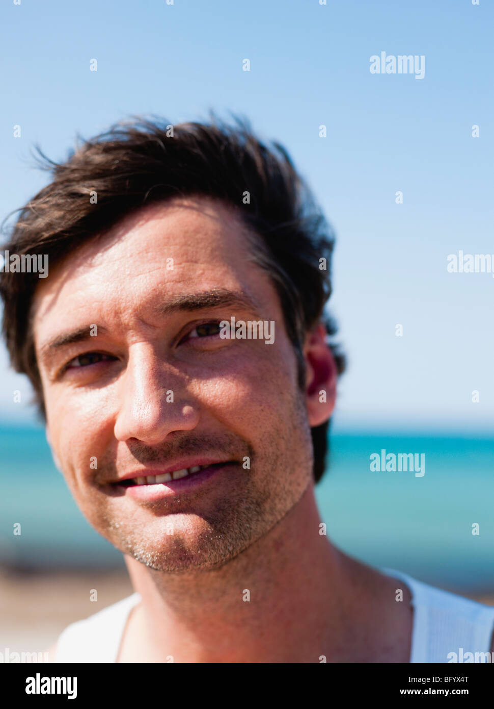 man on beach looking at viewer Stock Photo - Alamy