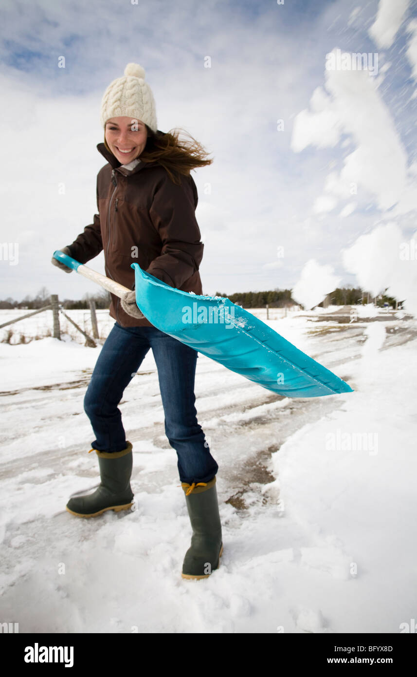 Woman snow shovel hi-res stock photography and images - Alamy