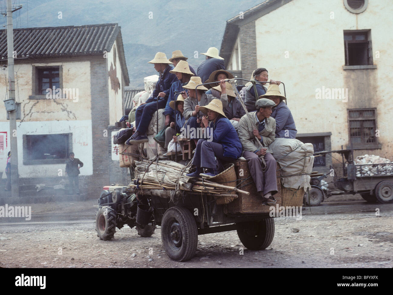 Field workers given lift back to town after a days work in Menghai ...