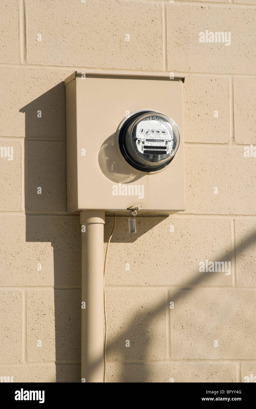 Electric meter on beige block masonry wall, American 110 volt, all ...