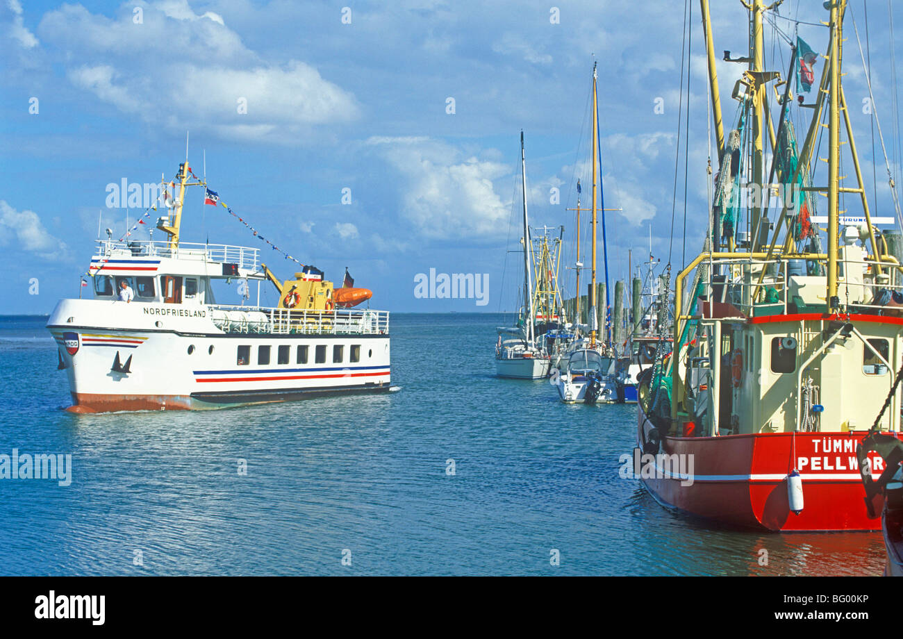 ferry and fishing trawler at the harbour of Pellworm Island, North Sea ...