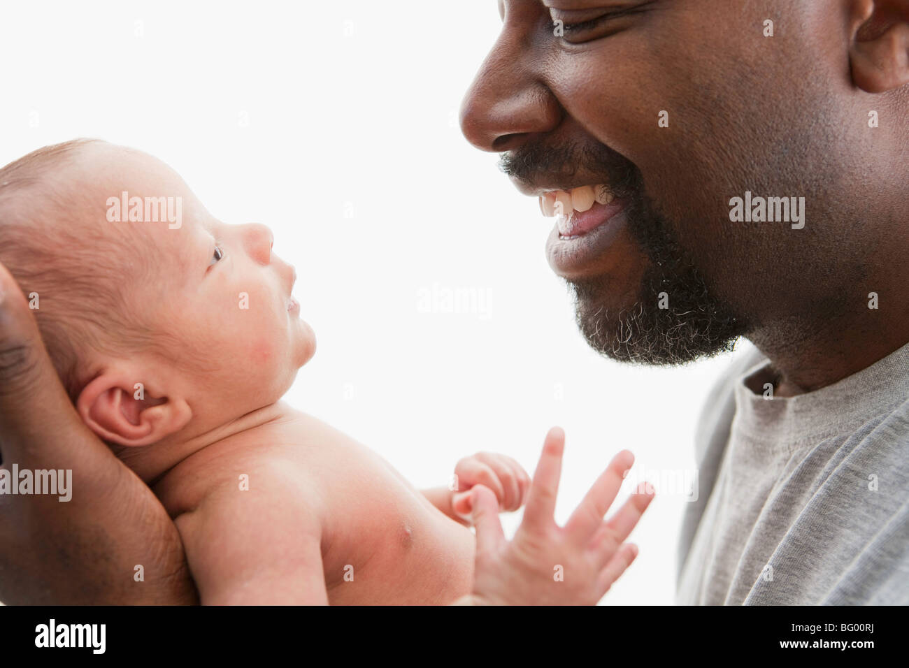Laughing father looking at young baby Stock Photo - Alamy