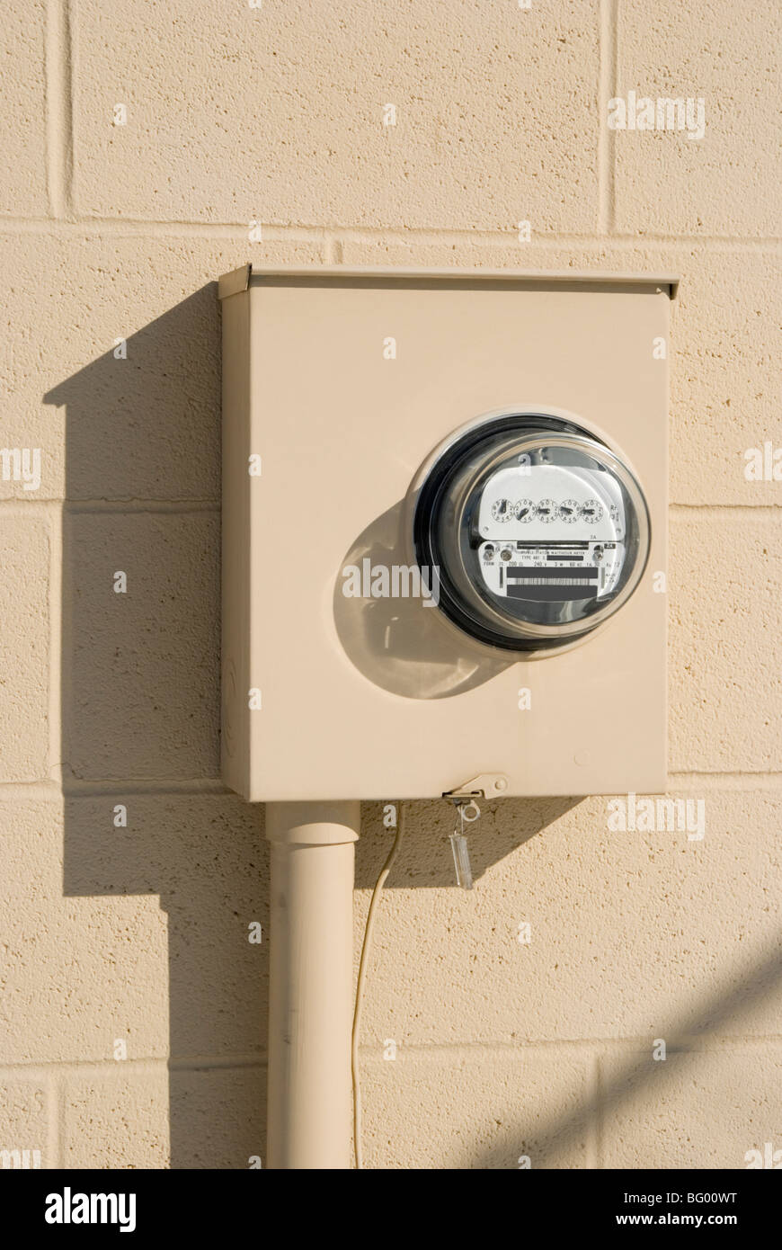 Electric meter on beige block masonry wall, American 110 volt, all ...