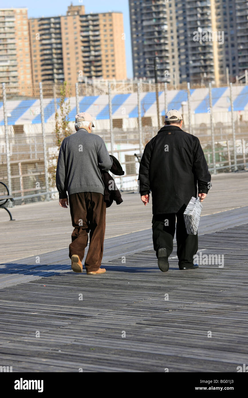 2 men walking on boardwalk, Coney Island, Brooklyn, NY Stock Photo - Alamy