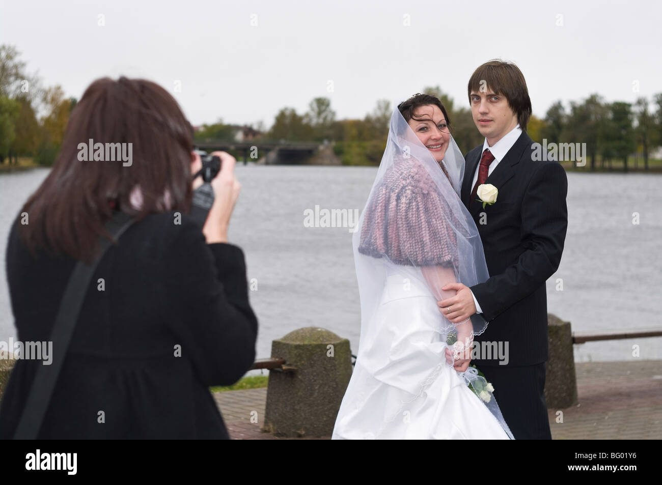 Couple are photographed on embankment. Take a picture Stock Photo - Alamy