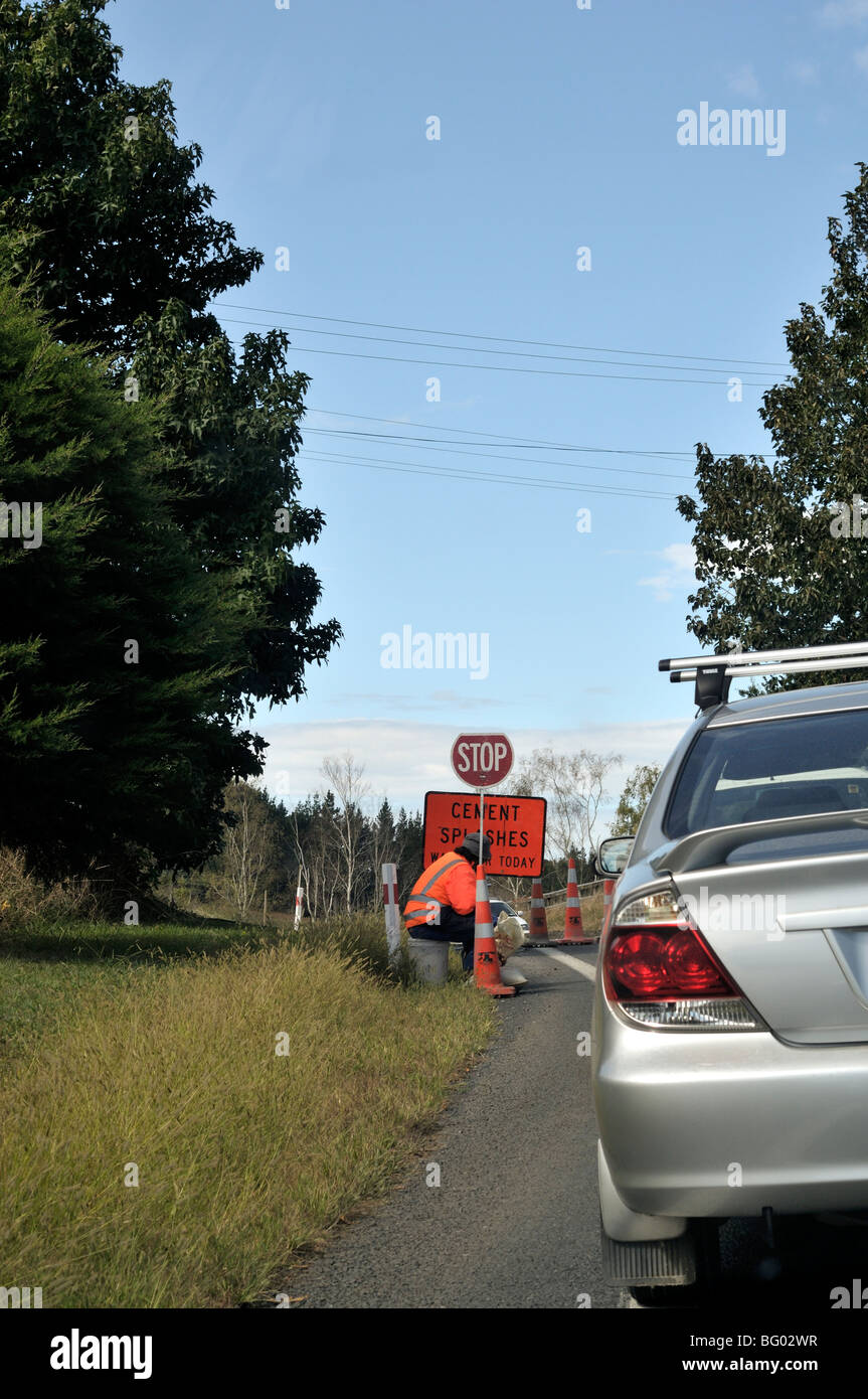 Man stopping traffic with stop sign due to resurfacing of road Stock ...