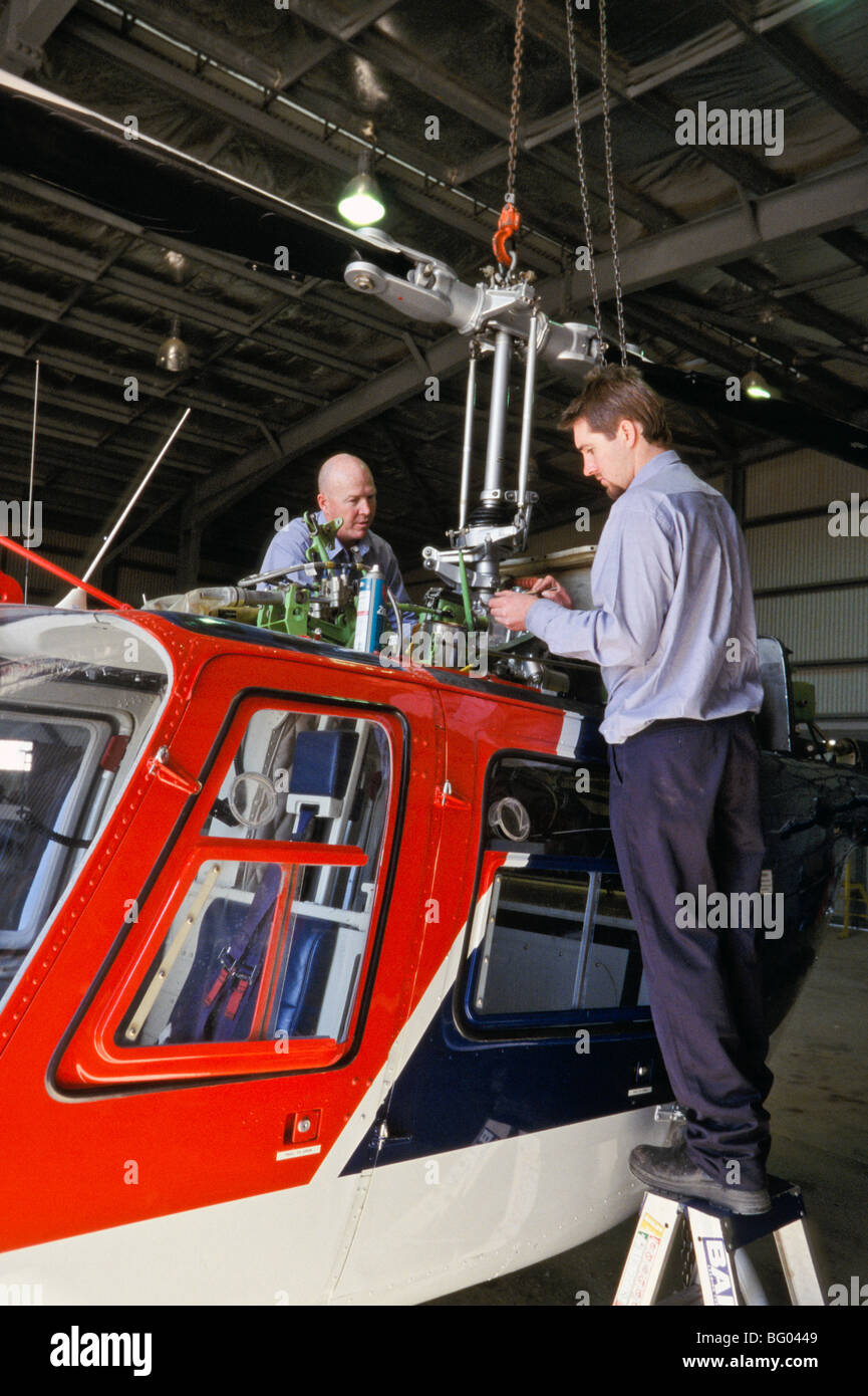 Engineers servicing helicopter Stock Photo - Alamy