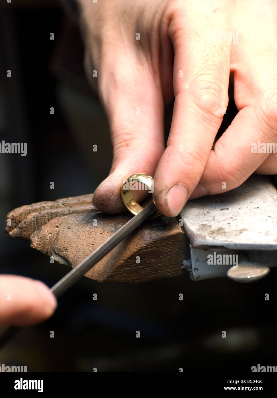 filing a gold ring in a jeweller's workshop Stock Photo - Alamy