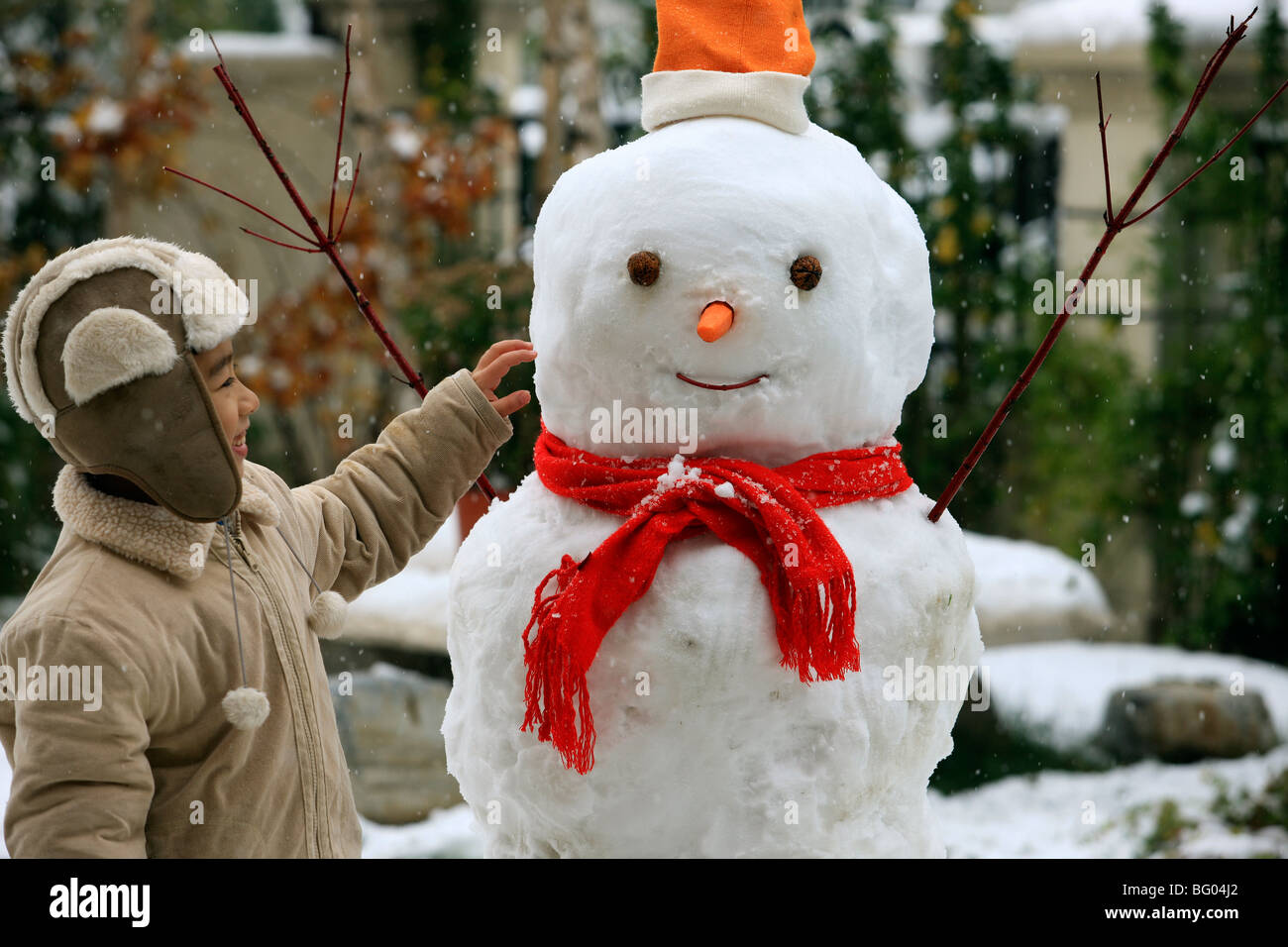 boy with snowman Stock Photo - Alamy