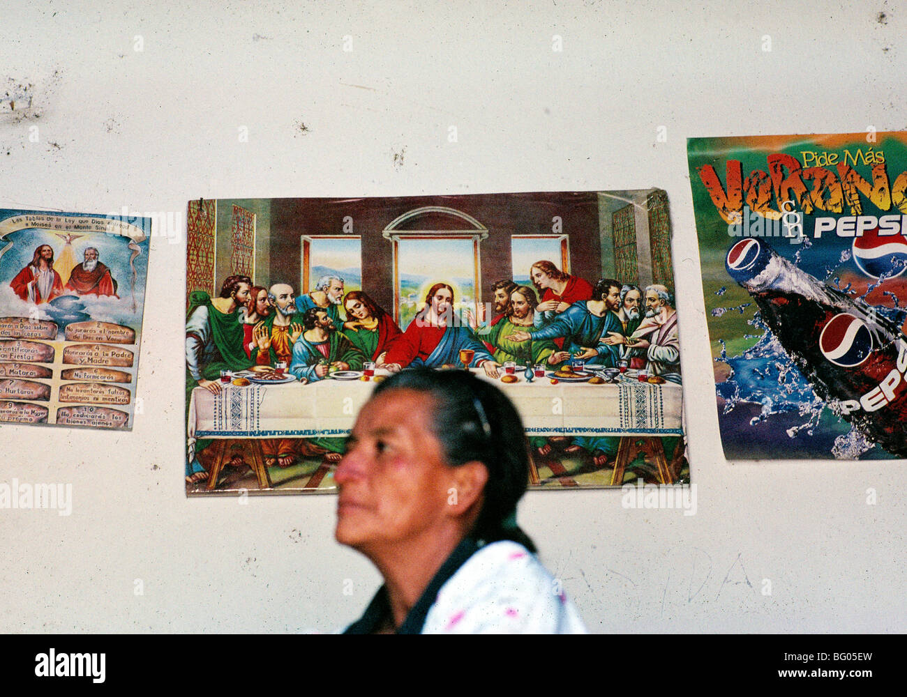 Portait of a woman standing in front of a poster of the Last Supper by ...
