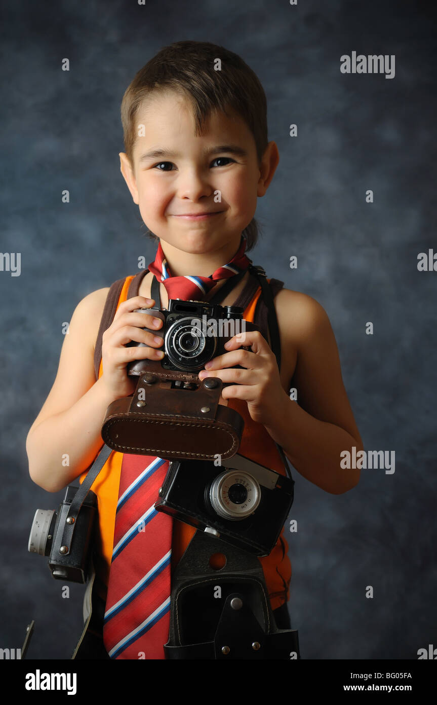 Young boy with cameras Stock Photo - Alamy
