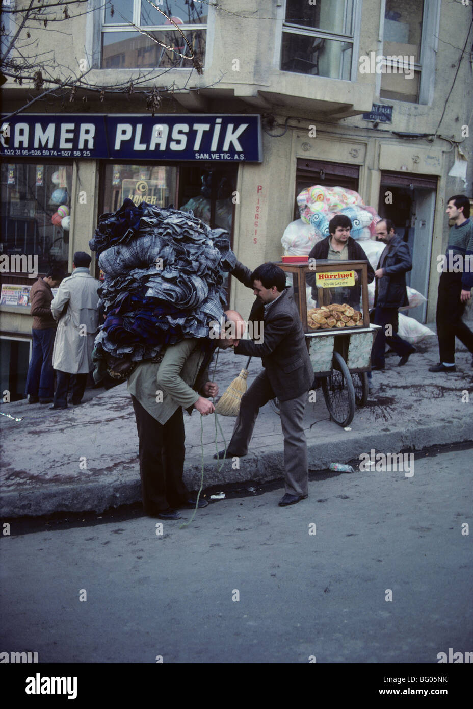 A door to door garment salesman gets loaded up in Istanbul, Turkey ...