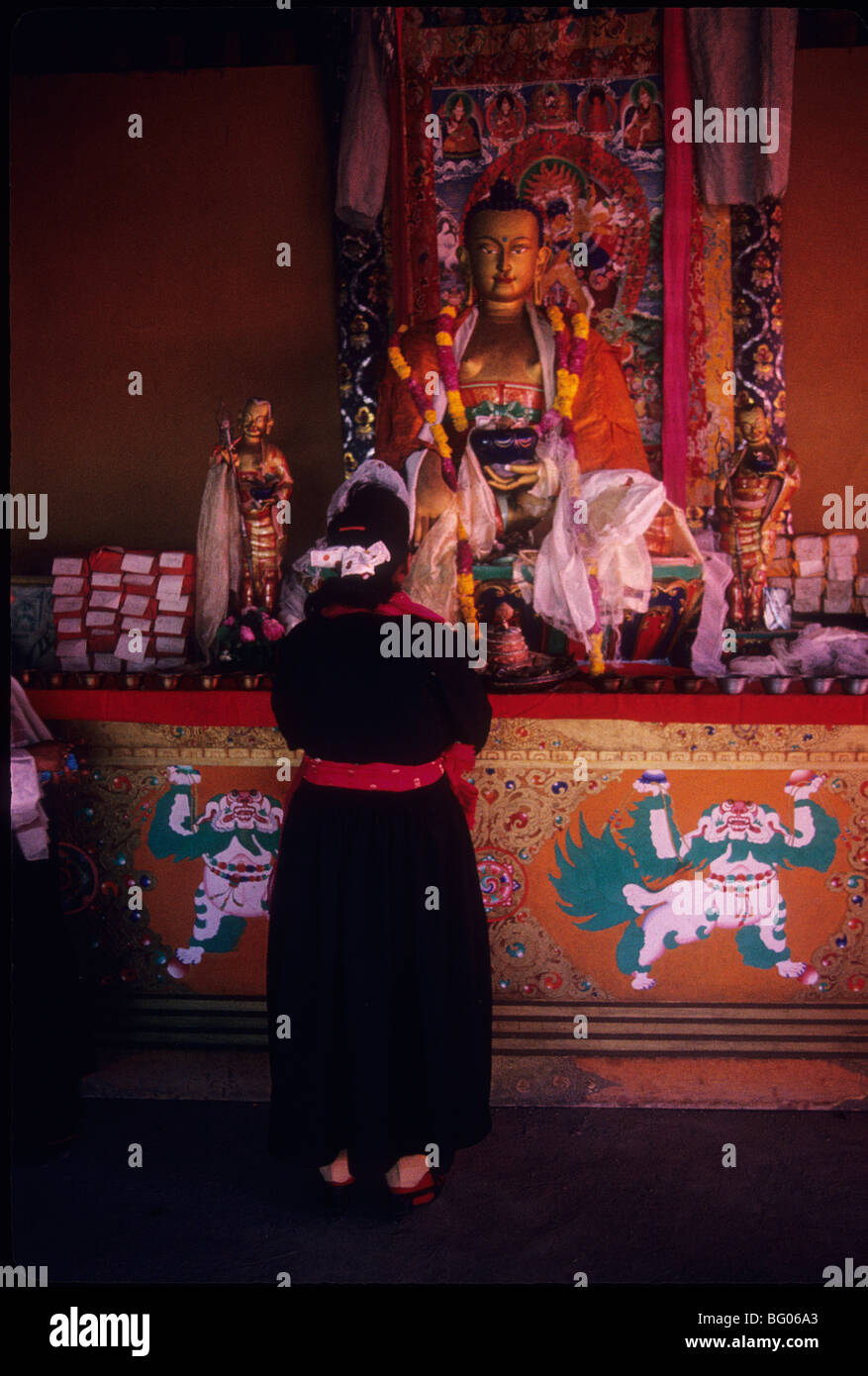 A Buddhist devotee stops to acknowledge Buddha in Leh the capitol of ...