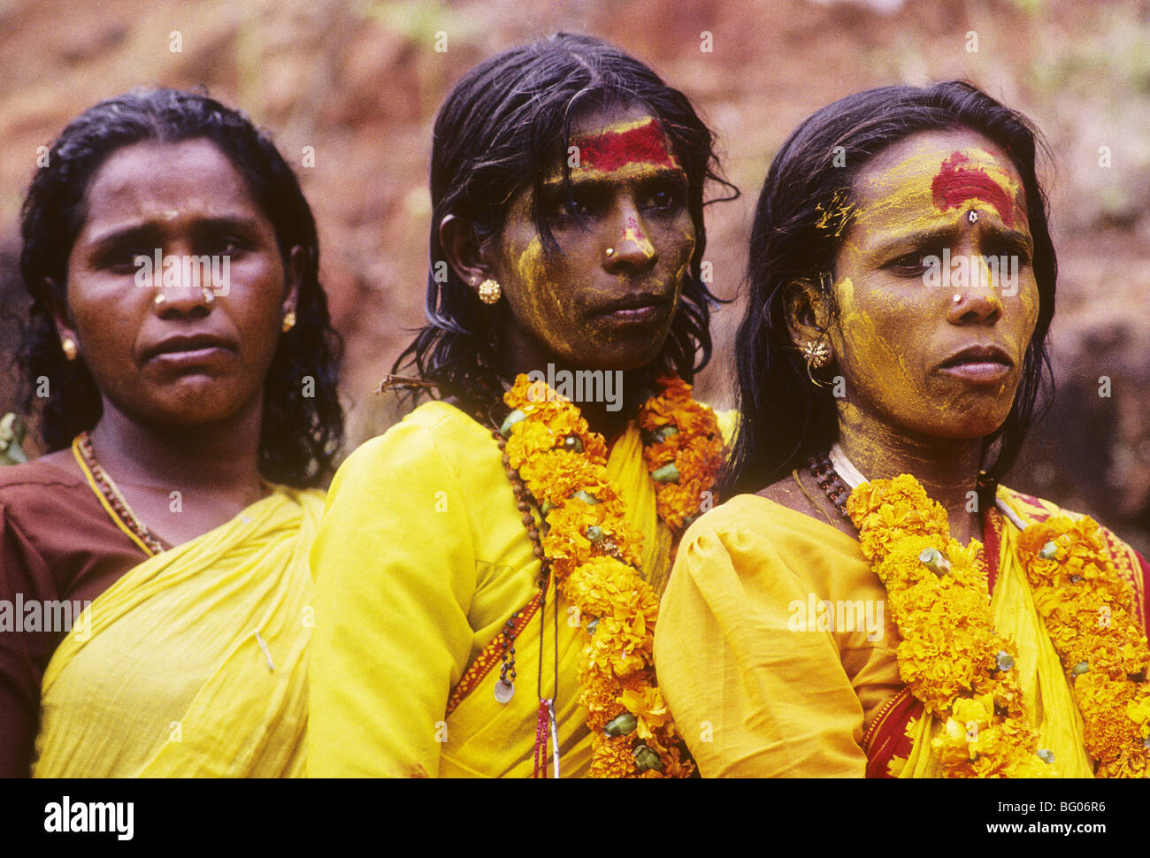 Three South India women wait in line to participate in a fire walking ...