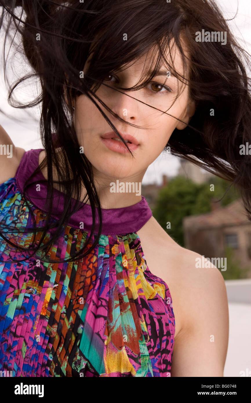 Beautiful model poses outside in a colorful dress Stock Photo - Alamy