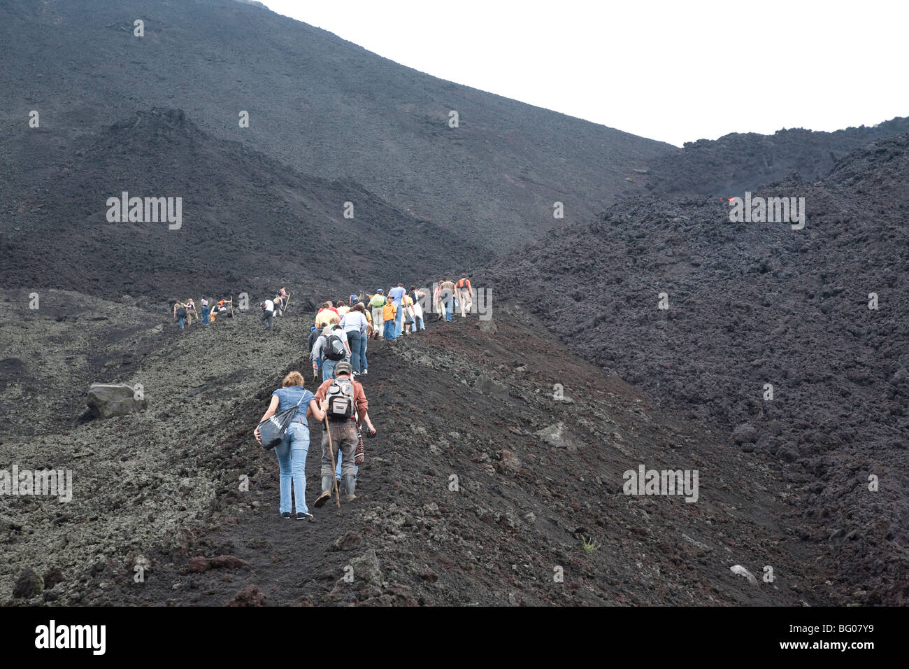 Scrambling up the scree slope towards the Pacaya Volcano Peak. Volcan ...