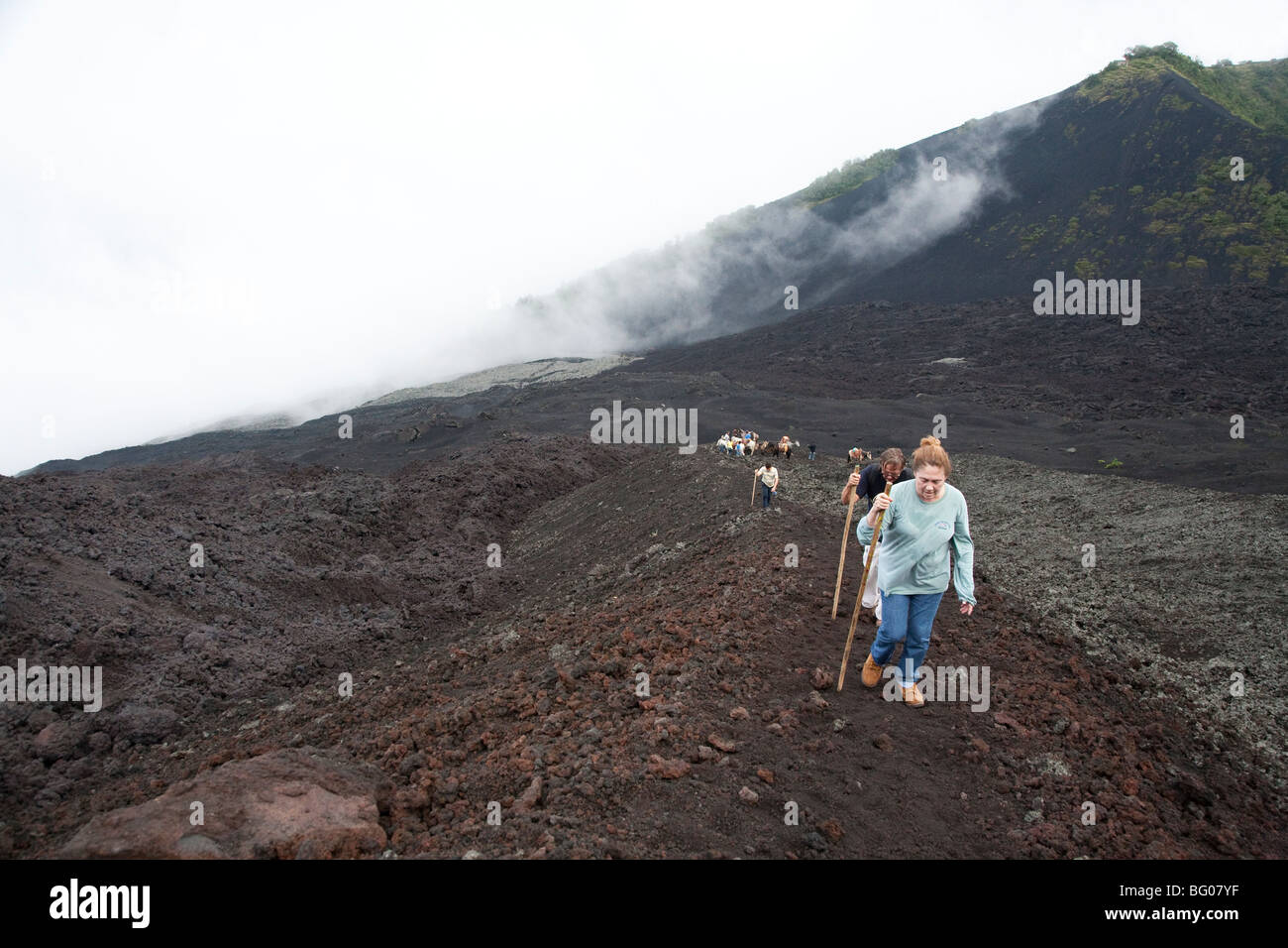Scrambling up the scree slope towards the Pacaya Volcano Peak. Volcan ...