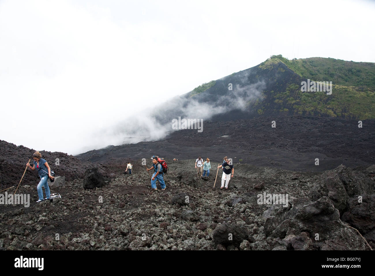 Scrambling up the scree slope towards the Pacaya Volcano Peak. Volcan ...
