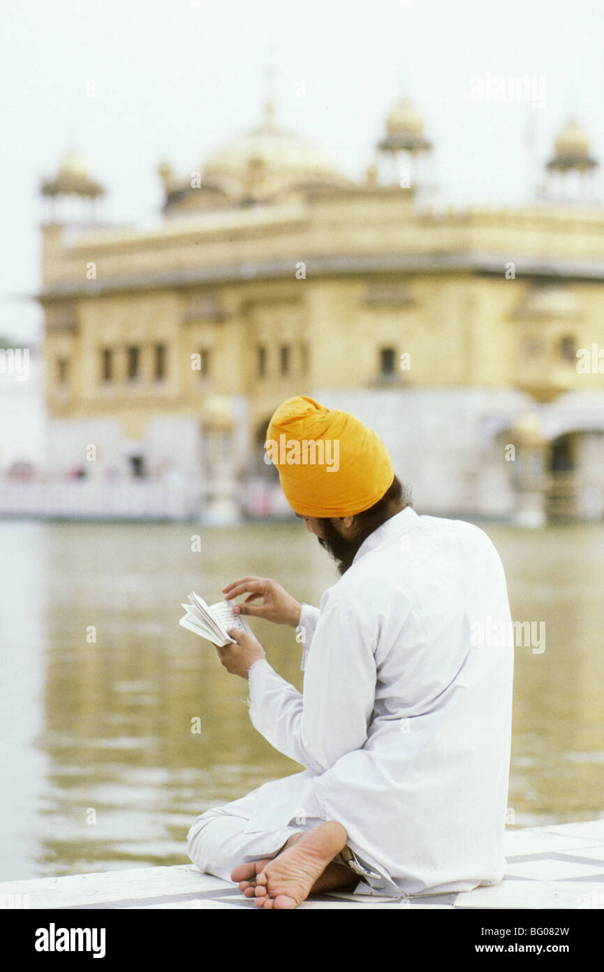 A Sikh pilgrim reads Sikh scripture at the Golden Temple the spiritual ...