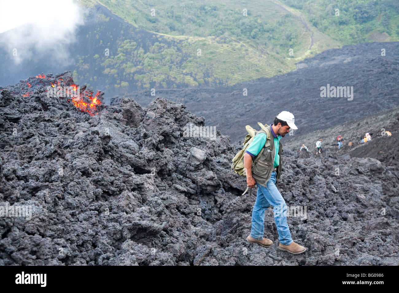 Flowing Lava and Tourist Guide towards the Pacaya Volcano Peak. Volcan ...