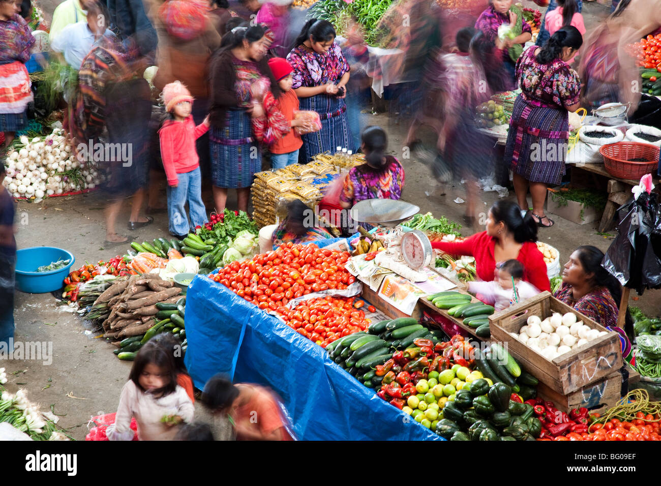 Shoppers and vendors at busy outdoor market, elevated view in ...