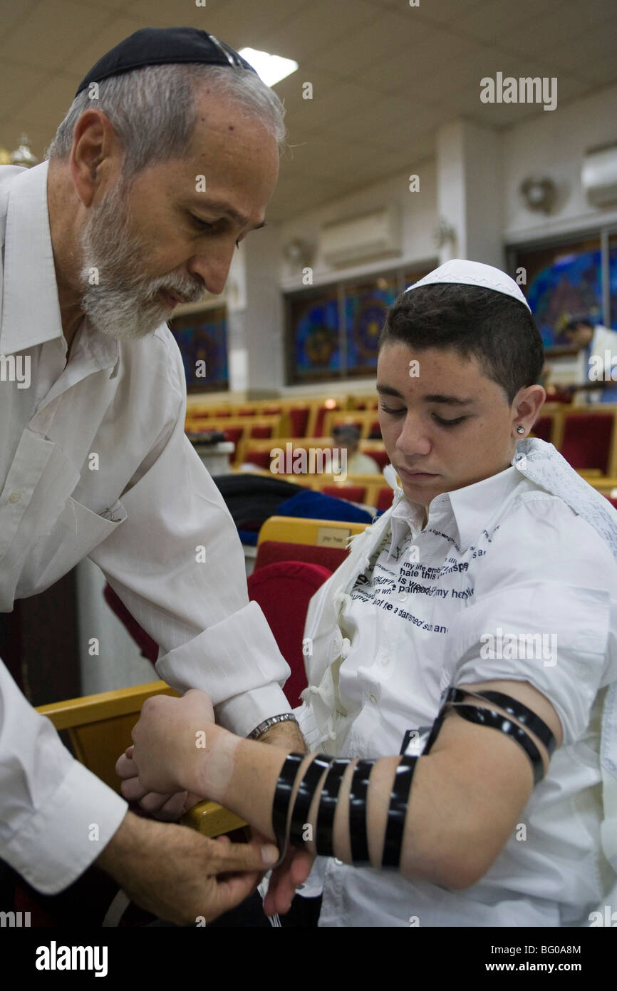 Bar Mitzvah boy laying tefillin (phylacteries) during ceremony Stock ...